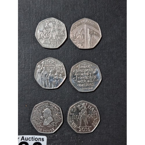 A collection of 19 collectable 50 pence piece coins, each coin has a ...