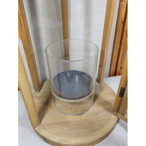 A large wooden framed tall pillar candle holder with glass centre piece ...