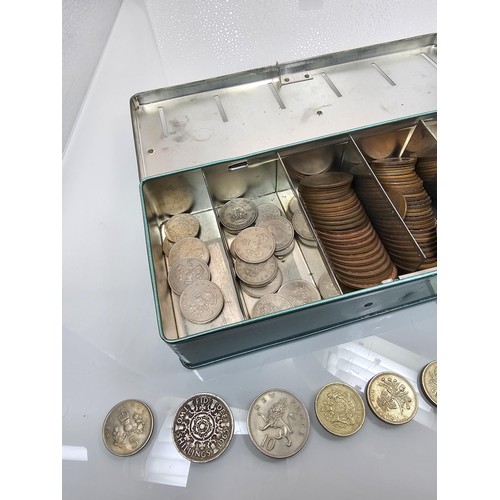 A good vintage metal coin saving tin containing a large quantity of ...