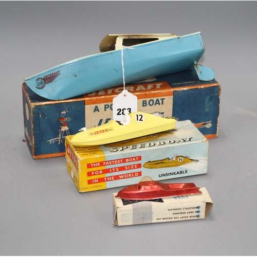 A boxed Jetex plastic fuel propelled model boat, a Jetcraft tinplate ...