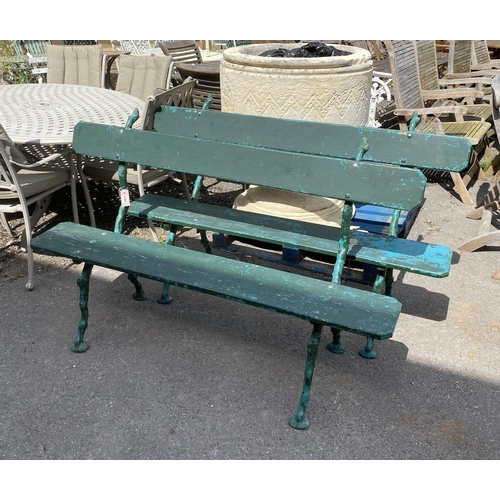 A pair of Victorian painted cast iron garden benches, length 150cm ...