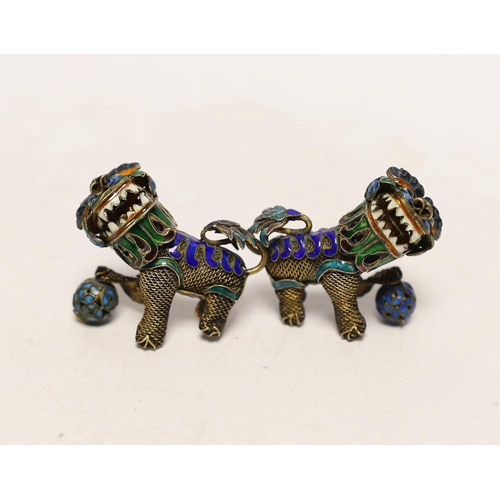 A pair of Chinese? gilt white metal and enamel Shi Shi, length 45mm.