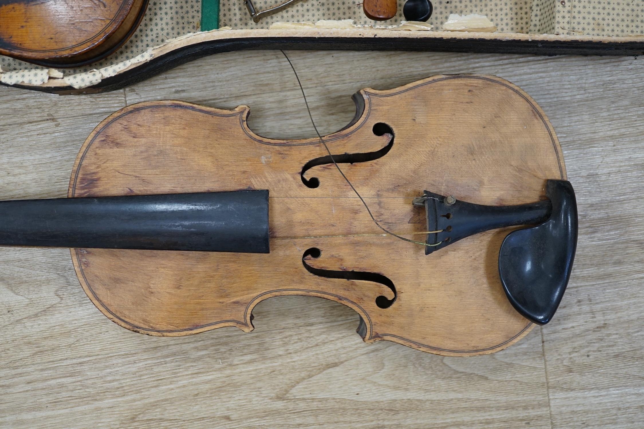 Two early 20th century violins, one in the remains of a case, both for restoration, length of bodies