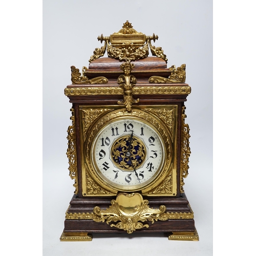 A French oak and brass mounted mantel clock with enamel dial, 42cm high