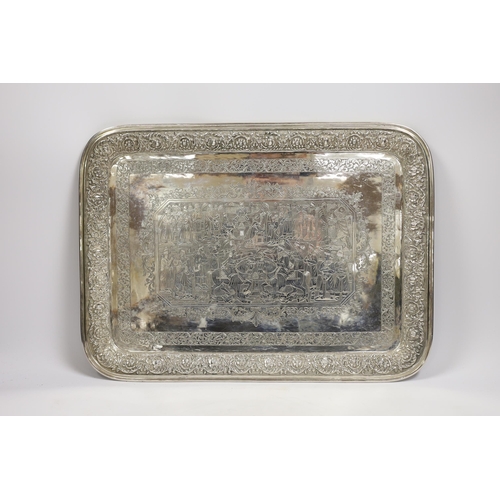 A Persian? engraved white metal tea tray, with embossed foliate border ...