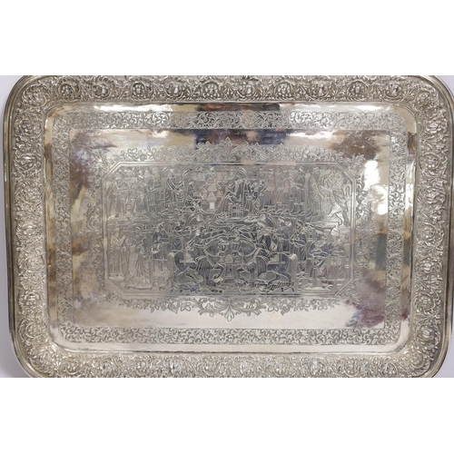A Persian? engraved white metal tea tray, with embossed foliate border ...