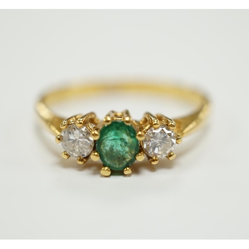 A modern 18ct gold, emerald and diamond set three stone ring, size P ...