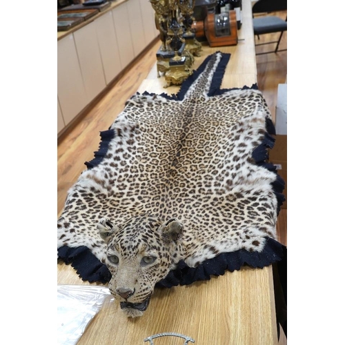 An early 20th century leopard skin rug with taxidermy head by van Ingen ...