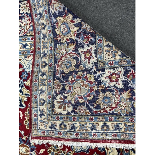 A Persian burgundy ground carpet, 410 x 282cm. Condition - good