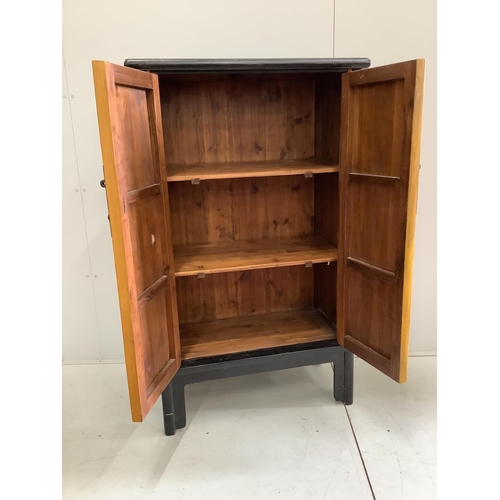 A small modern Chinese two door wardrobe, decorated with birds and ...