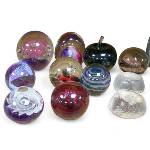 Twenty three glass paperweights, including five with silhouettes of ...