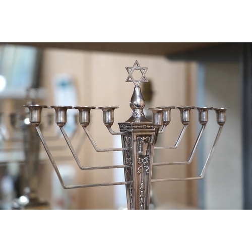 A modern silver Hanukkah Menorah, on a square base with four claw and ...