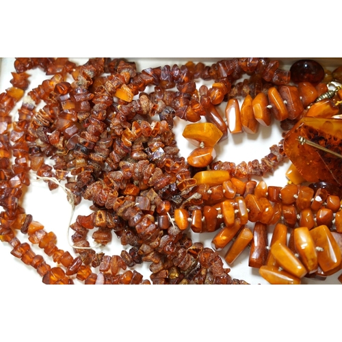 Five assorted single strand amber necklaces, including jagged pebble ...
