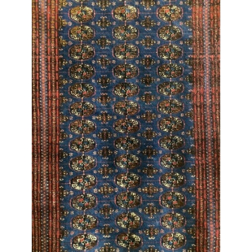 A Bokhara blue ground rug, 189 x 130cm