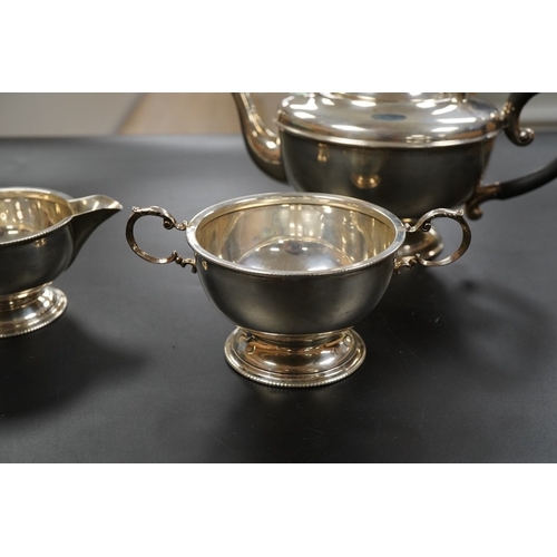 A George V silver three piece tea set A George V silver three piece tea ...
