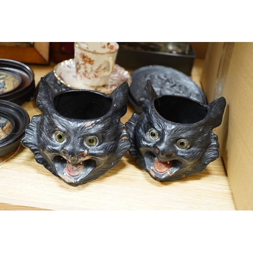 Two framed pot lids, two oval figural plaques,a moustache cup and ...