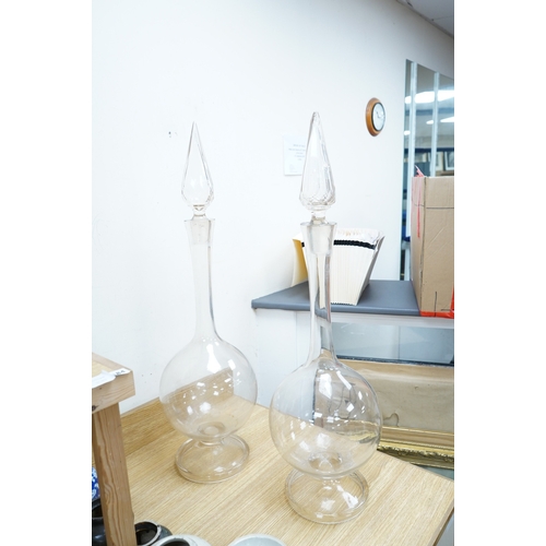 A pair of large clear glass chemist window display bottles and stoppers ...