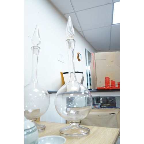A pair of large clear glass chemist window display bottles and stoppers ...