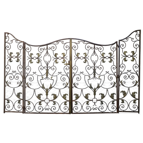 A pair of French wrought iron gates, c.1900, decorated with sinuous ...