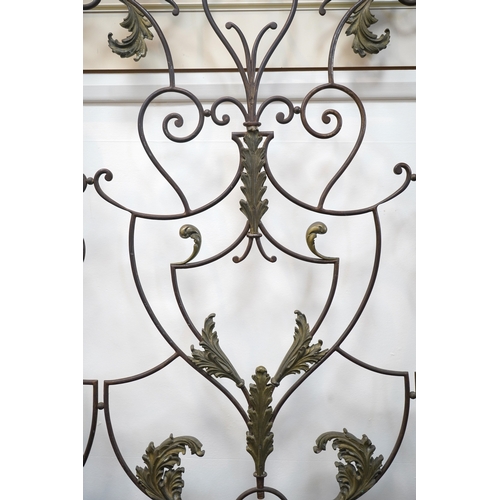 A pair of French wrought iron gates, c.1900, decorated with sinuous ...