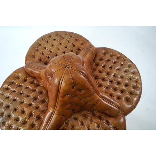 A contemporary Victorian style buttoned tan leather conversation seat ...