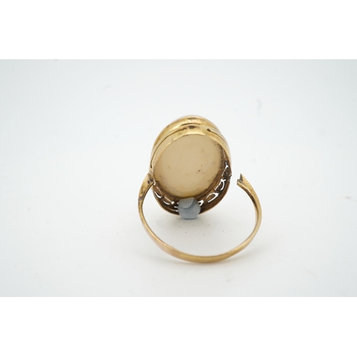 An opal ring, collet-set with an oval opal cabochon measuring ...