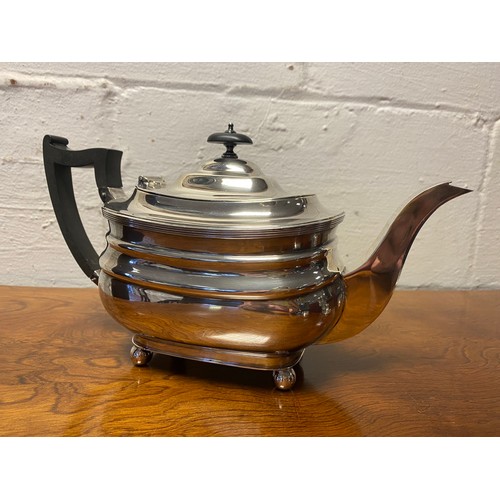 An early 20th century silver teapot, Sheffield 1936, on ball feet