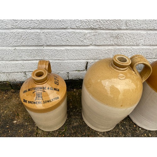 A group of four stoneware flagons, including one signed for Giddings of ...