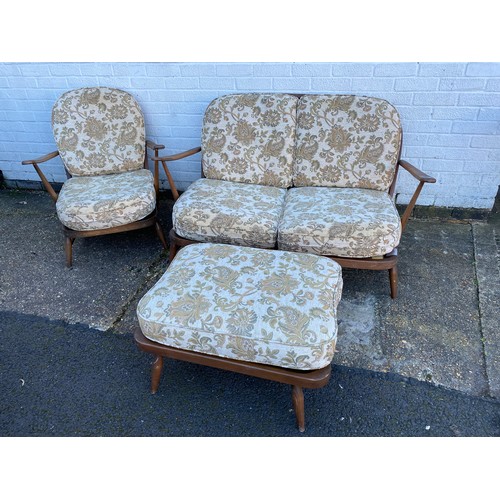 An Ercol cottage suite, comprising two seater settee, armchair and stool