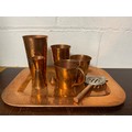 A contemporary copper bar set, comprising tray, jigger, pair of cups ...