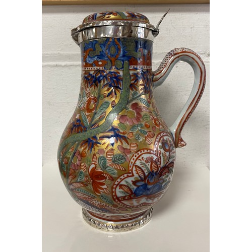 A Chinese jug applied with silver mounts, decorated with flowers and ...
