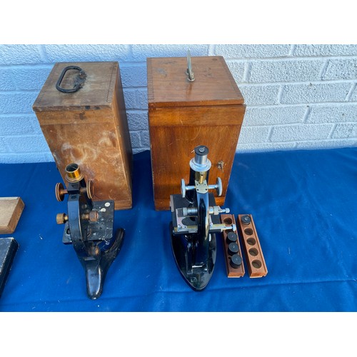 Two cased microscopes, one with military crows foot