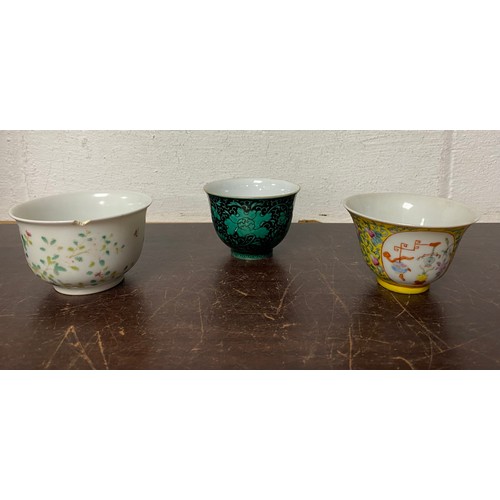 Three Chinese porcelain tea bowls, comprising one enamelled on a yellow ...