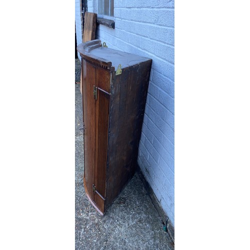 A 19th Century oak bow fronted corner cupboard