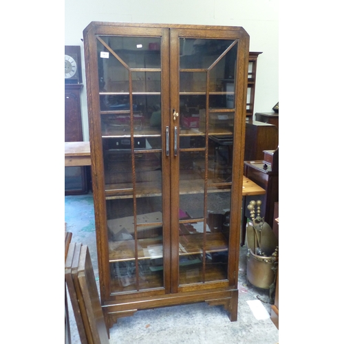 Oak Art Deco glazed bookcase/display cabinet, key present, height 176cm.