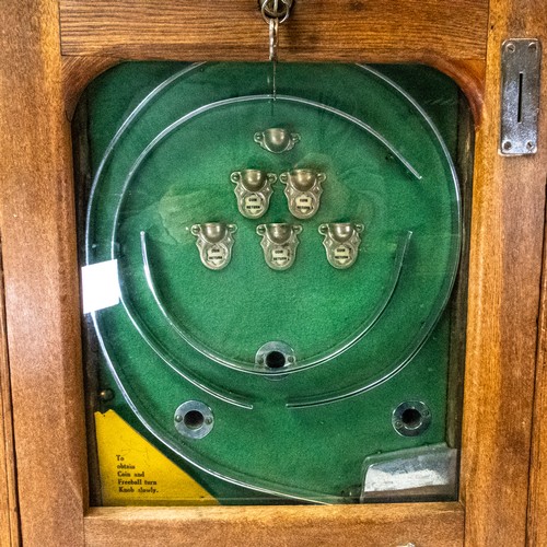 An early 20th century 'Flick Ball' penny slot machine, housed in a ...