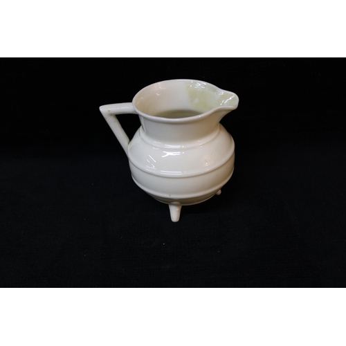 A small Belleek cream jug - 7.5cmH - unmarked