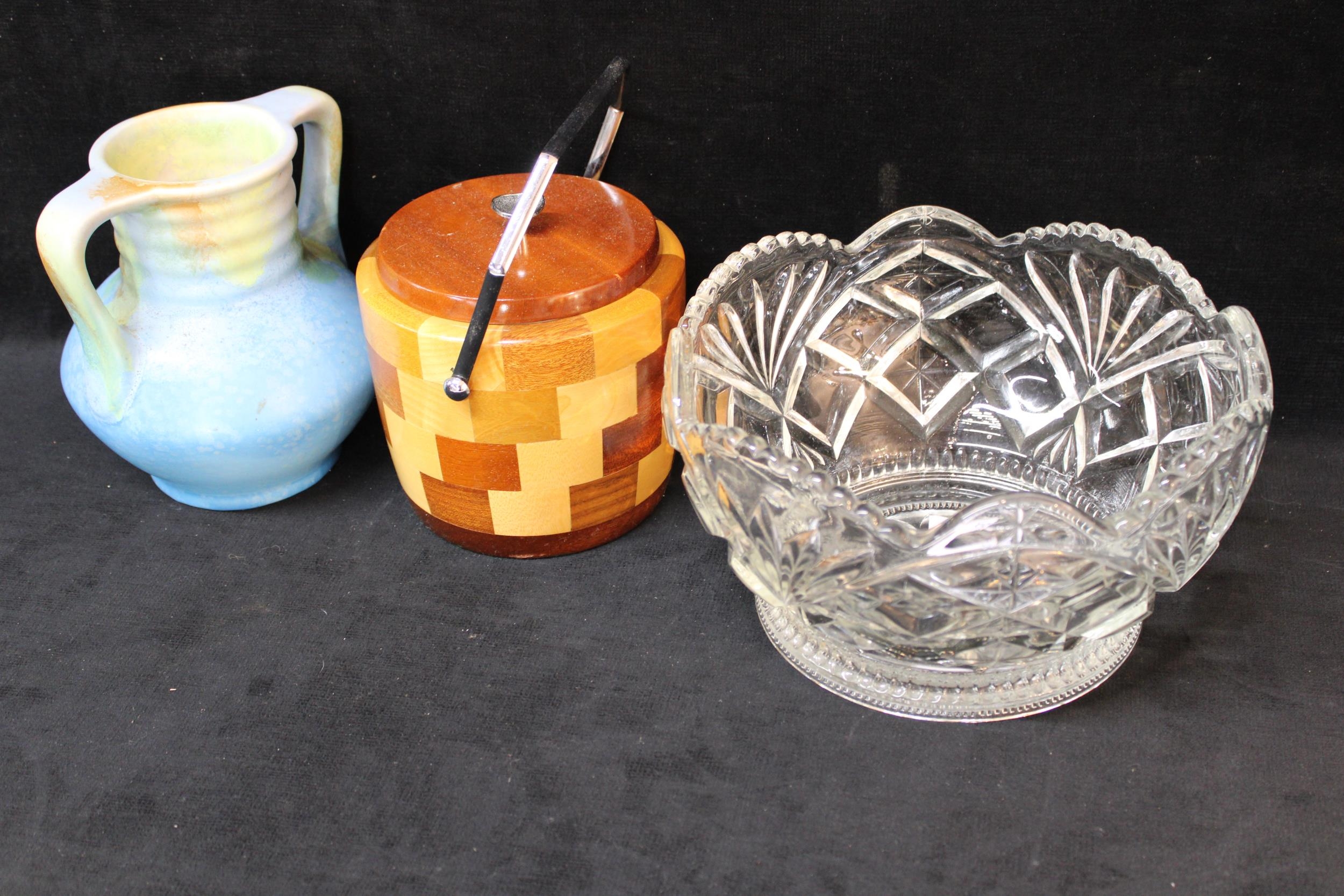 A glass fruit bowl, ice bucket and blue vase