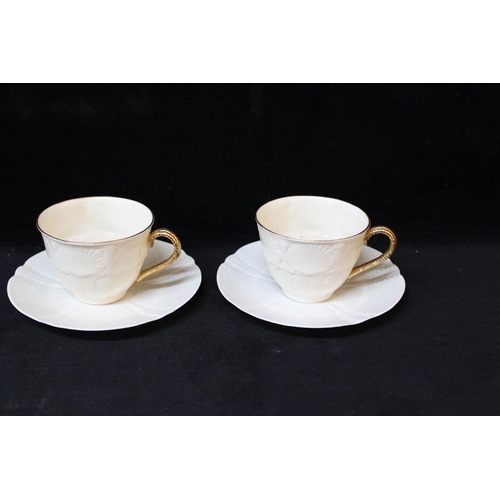 Two 6th period Belleek cups and saucers, saucers unmarked