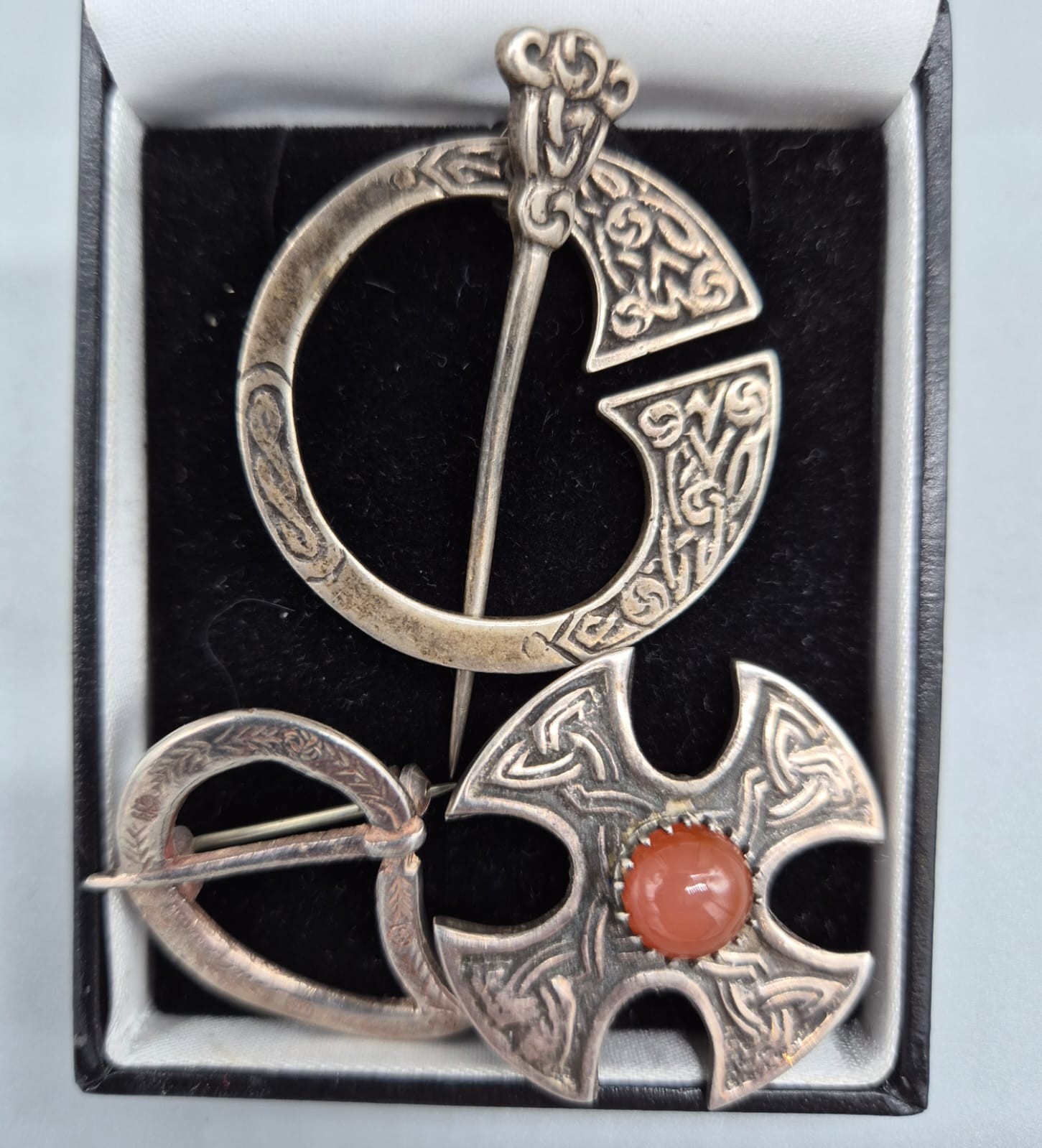 Three Scottish brooches; Robert Allison Glasgow silver and orange agate ...