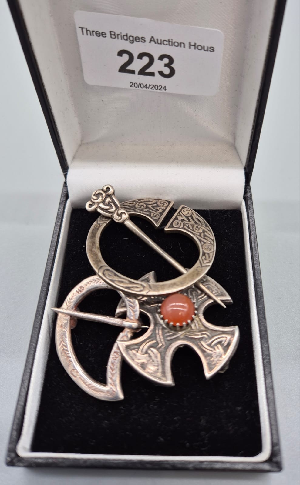 Three Scottish brooches; Robert Allison Glasgow silver and orange agate ...