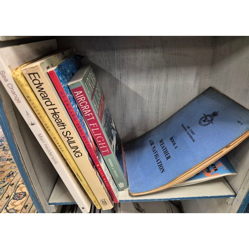 Boat shaped shelving unit containing two carved wooden sailor figures ...