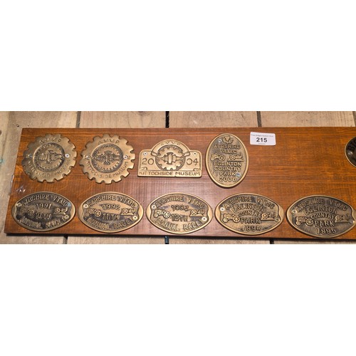 Wooden wall plaque having various brass steam fair plaques attached ...