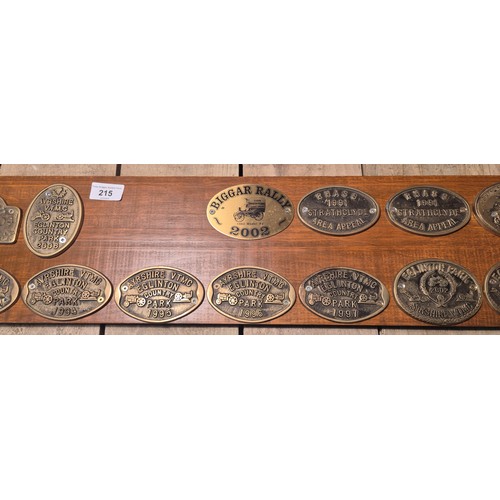 Wooden wall plaque having various brass steam fair plaques attached ...