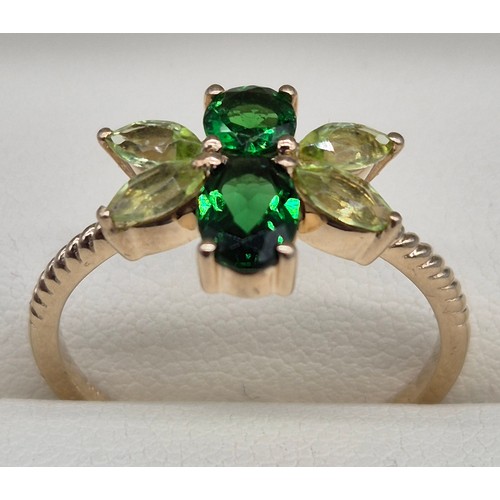9ct yellow gold and green gem stone ring. Gems form a bug shape. Ring ...