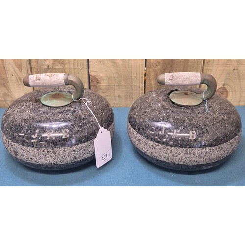 Pair of two early 20th century curling stones with handles. Having ...
