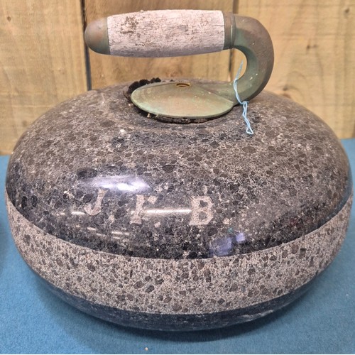 Pair of two early 20th century curling stones with handles. Having ...
