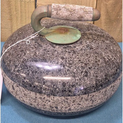 Pair of two early 20th century curling stones with handles. Having ...
