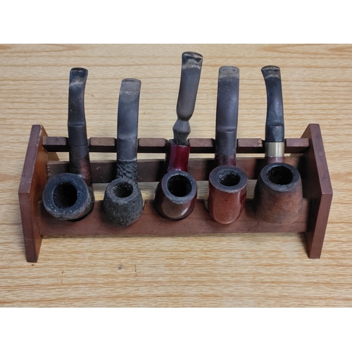 A Duncan pipe stand full of curved pipes. Pipes include Riviera ...