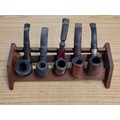 A Duncan pipe stand full of curved pipes. Pipes include Riviera ...